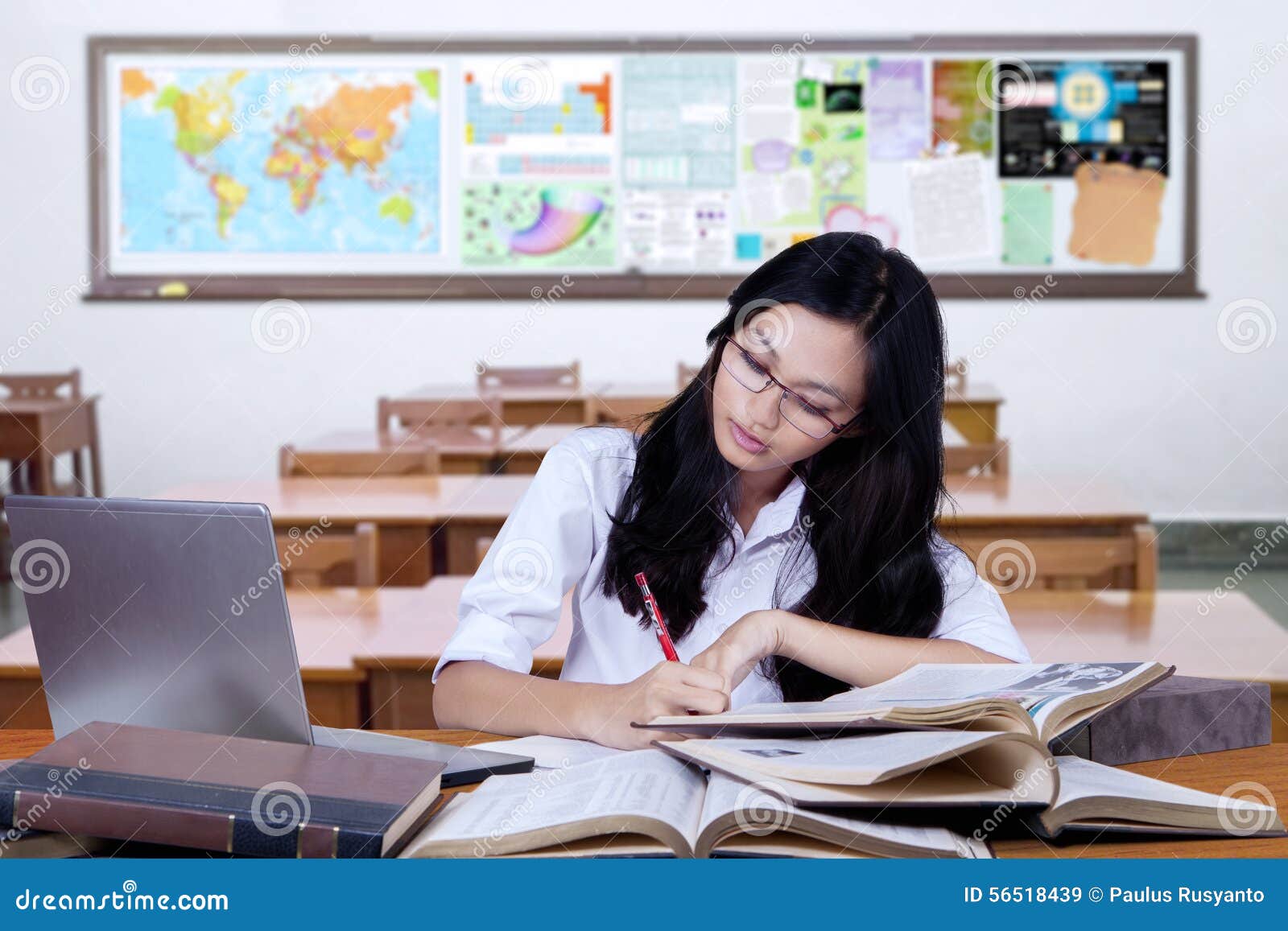 Student Writing on Books in the Classroom Stock Image - Image of ...
