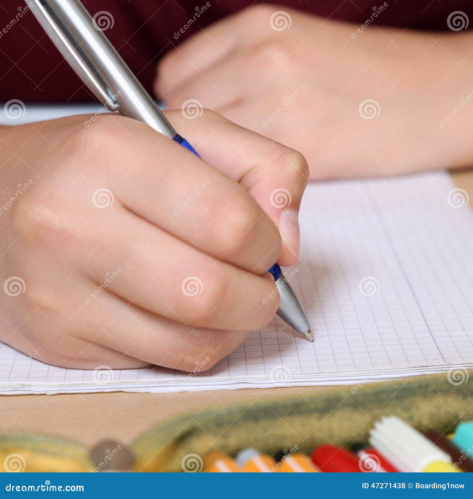Student Writing with Hand in His Exercise Book at School Stock Photo ...