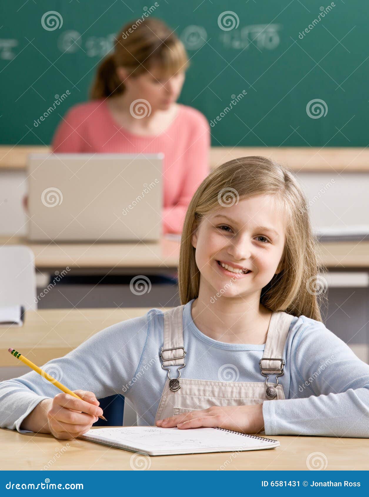 Student Writing in Notebook in Classroom Stock Image - Image of girl ...