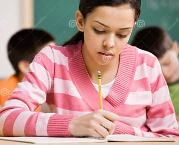 Student Writing in Notebook in School Classroom Stock Image - Image of ...