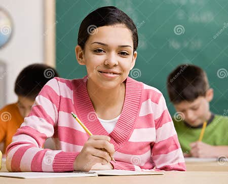 Student Writing in Notebook in School Classroom Stock Image - Image of ...