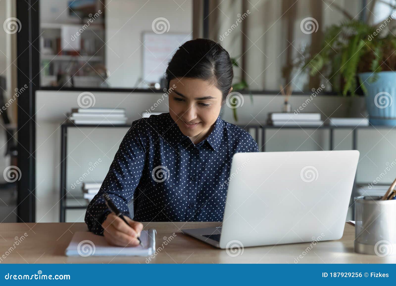 Student Writing on Notepad Do Assignment Seated at Desk Stock Photo ...