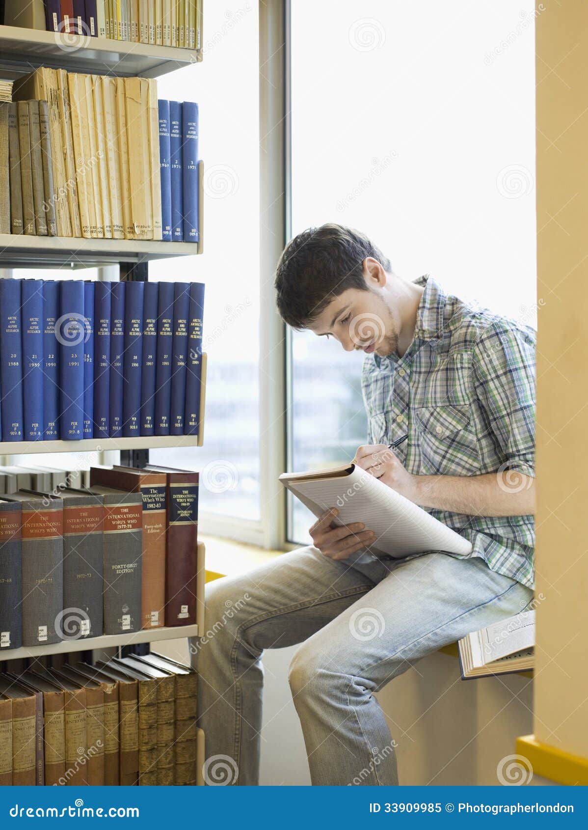 Student Writing Notes on Windowsill in Library Stock Image - Image of ...