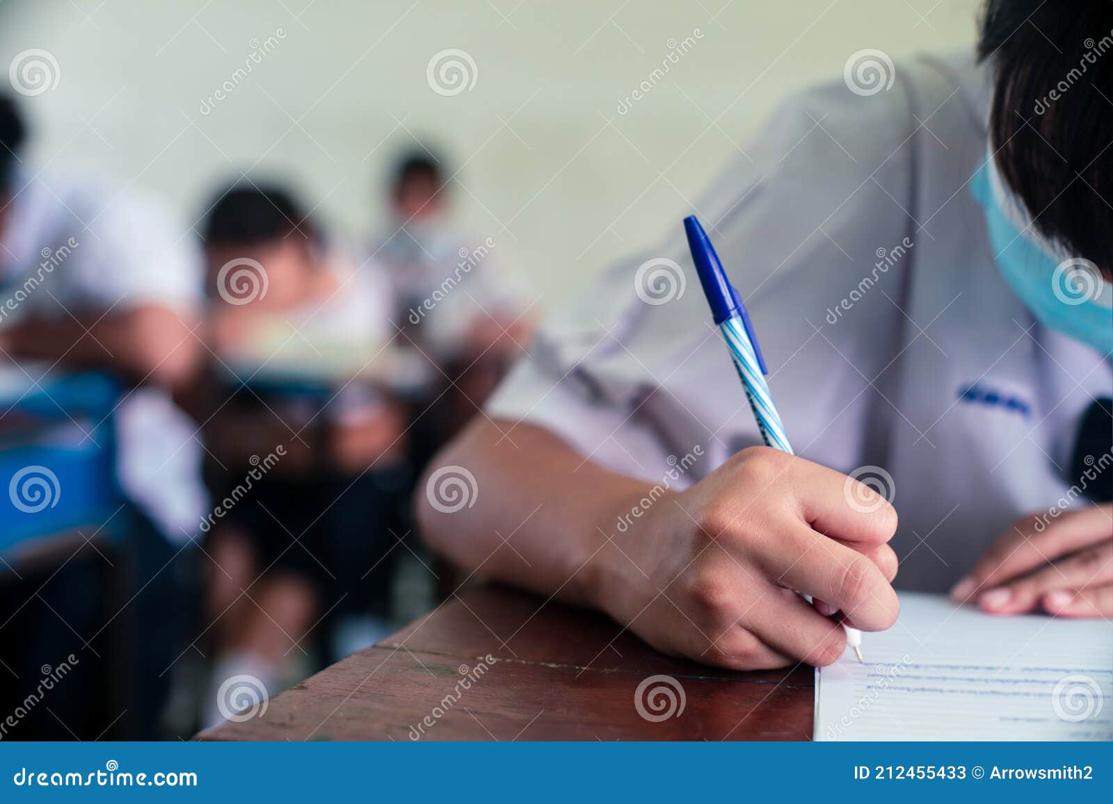 Student Writing Pen in Hand Doing Exams Answer Sheets Exercises in ...