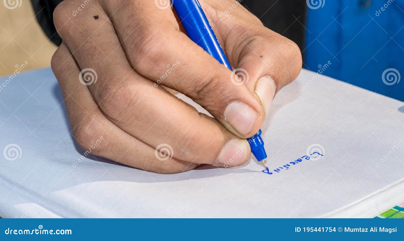 A Student is Writing on a White Paper with a Pen Stock Photo - Image of ...