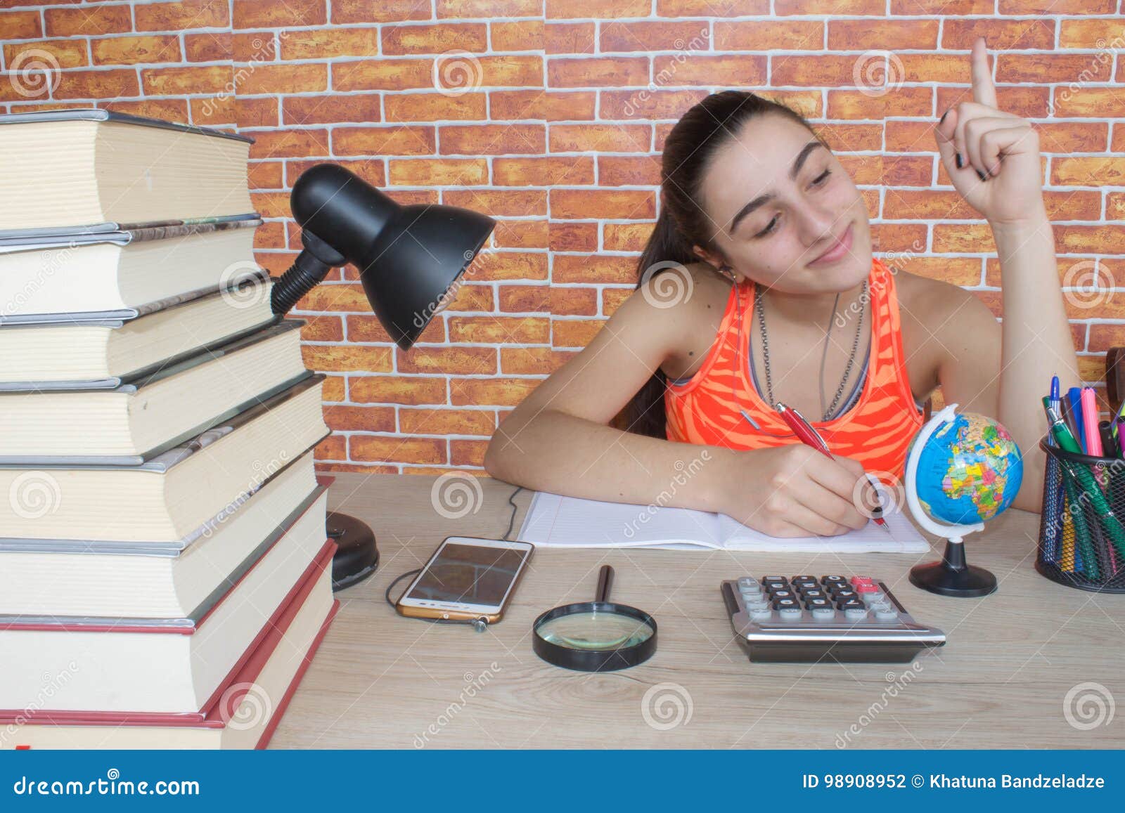 Student, Girl Write in Notebook between Books. Young Attractive Student ...