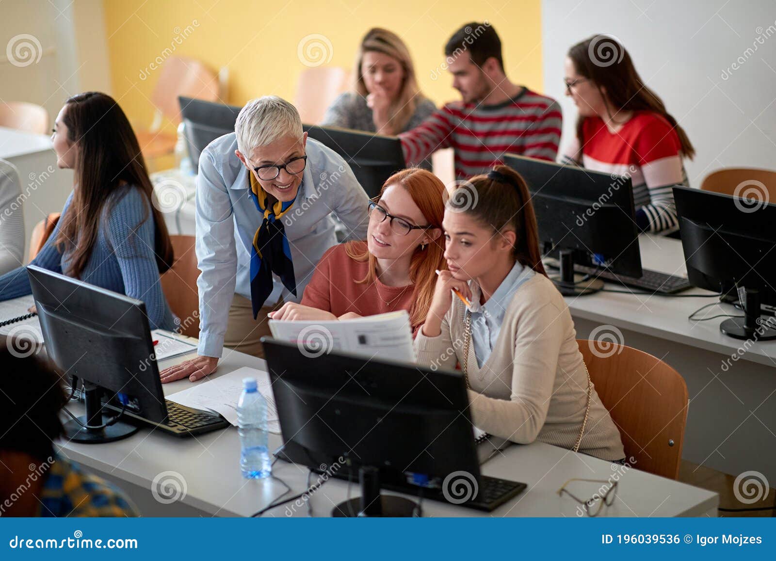 Students Asking Female Professor for Help at an Informatics Lecture ...