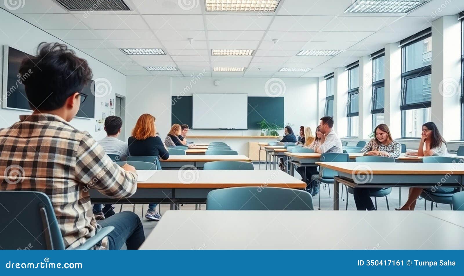 Engaged Classroom With Students Raising Hands Stock Image ...