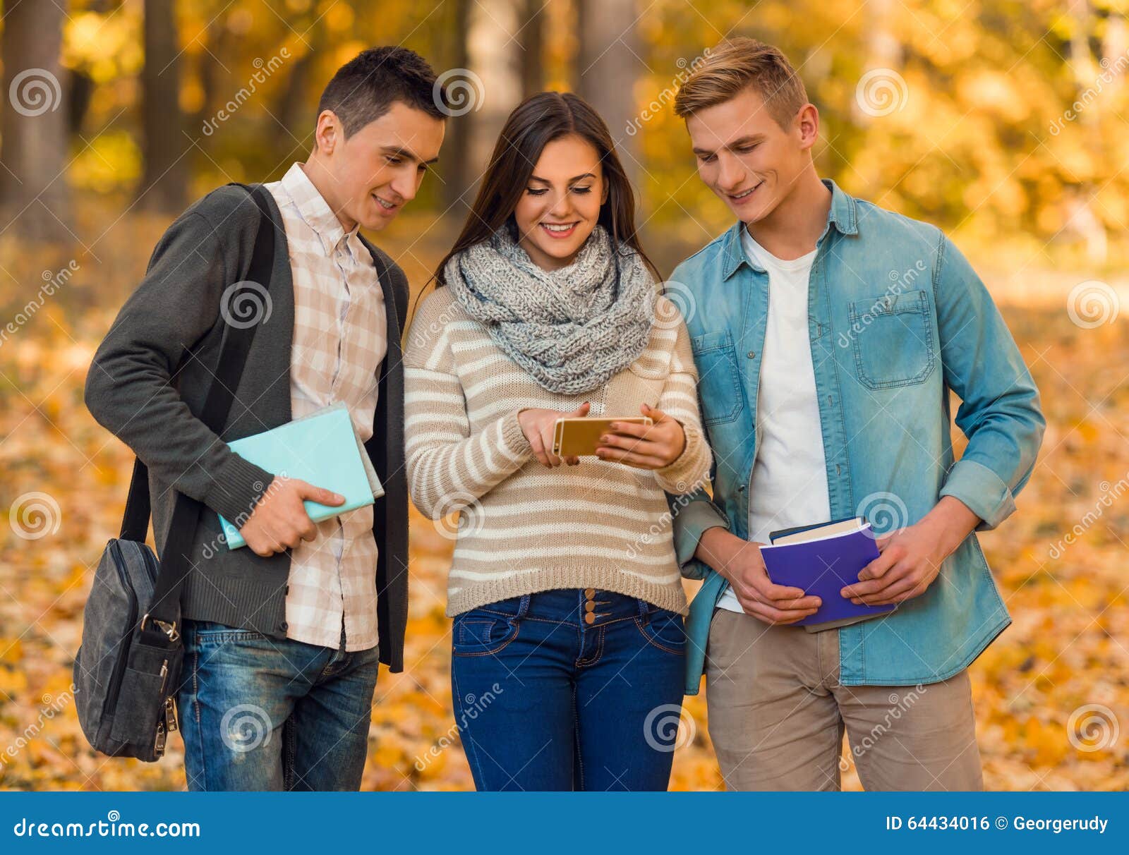 Students in autumn park stock photo. Image of person - 64434016