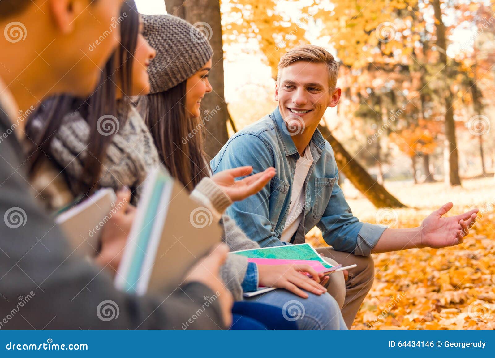 Students in autumn park stock photo. Image of phone, attractive - 64434146