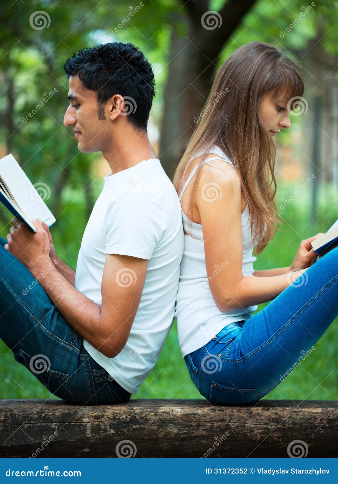 Students Back To Back Reading a Book Outdoors Stock Photo - Image of ...