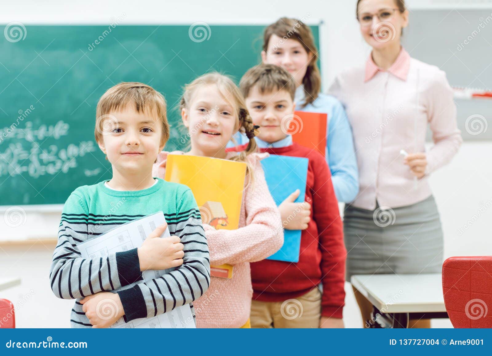 Students with Books and Teacher Standing in School Class Stock Photo ...