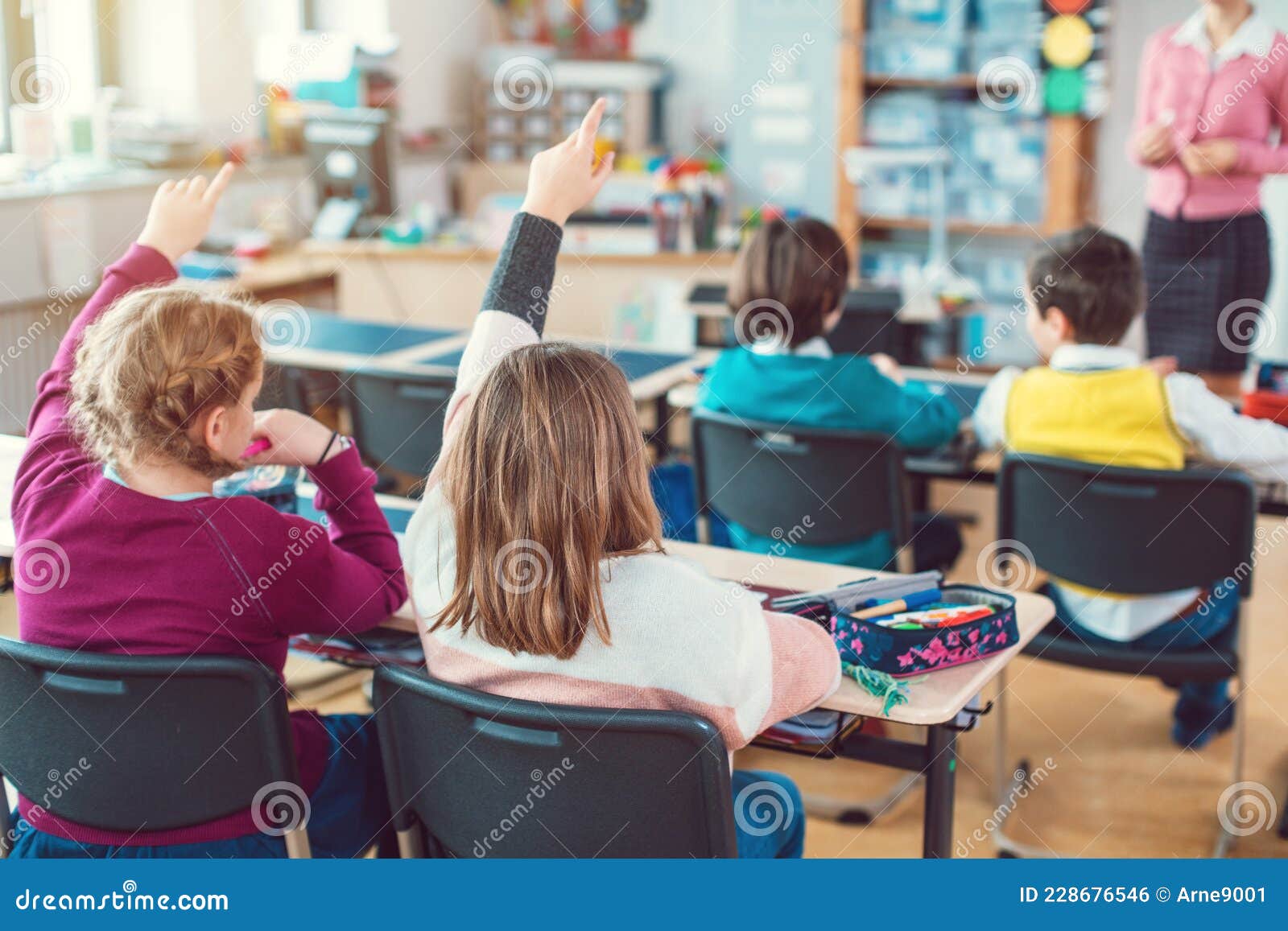 Students in Class Eager To Answer a Question To Their Teacher Stock ...