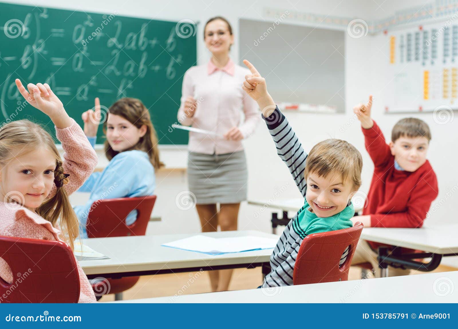 Students in Class Raising Hands To Answer a Question Stock Image ...