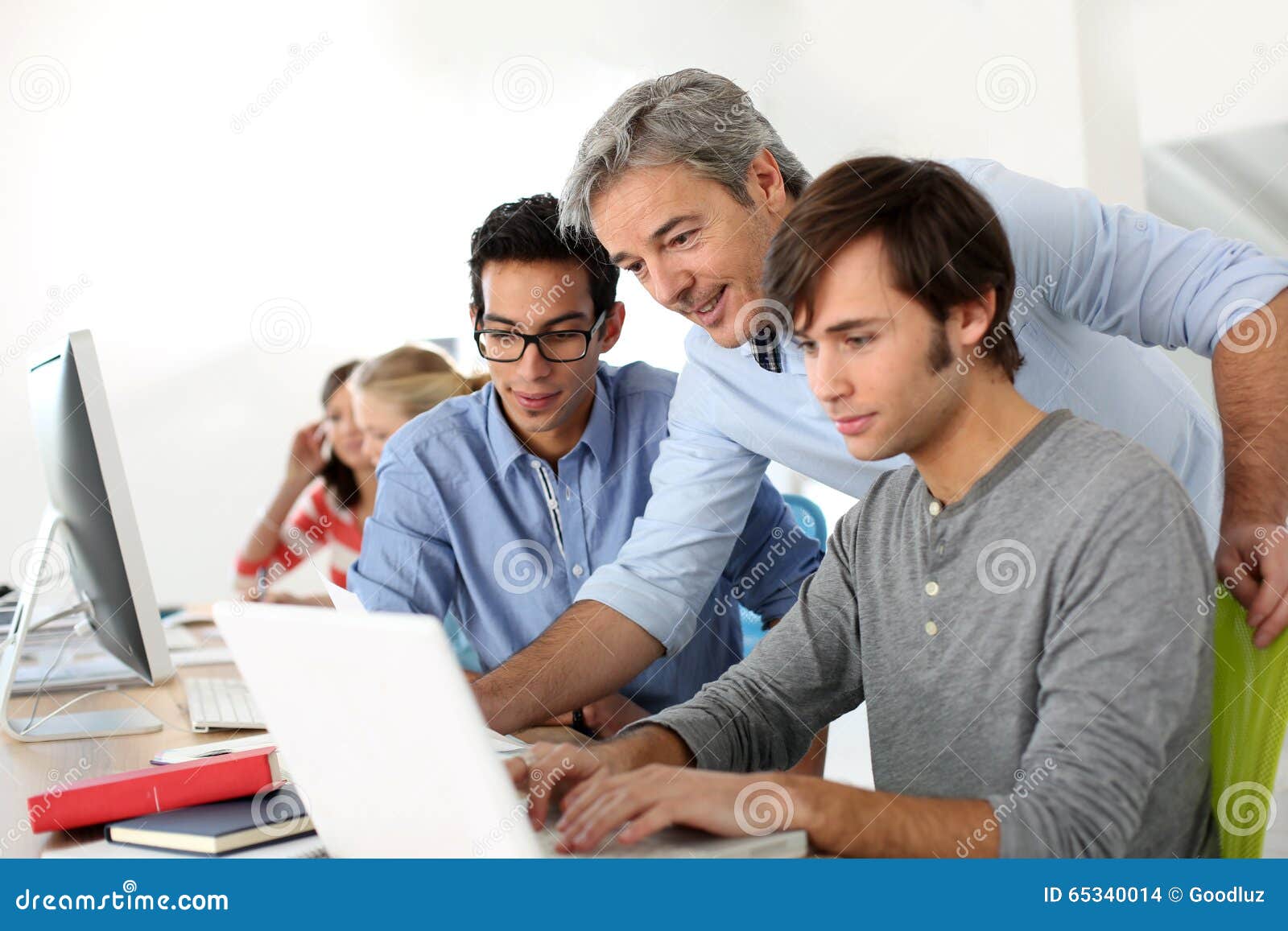 Students in Classroom with Professor Helping Them Stock Photo - Image ...
