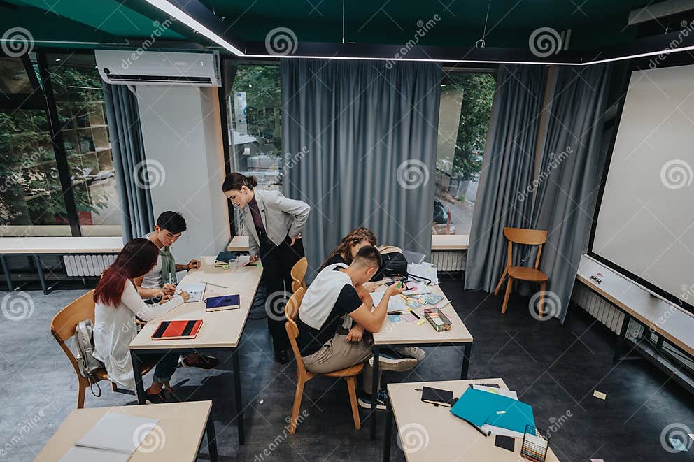 Students Collaborating in a Classroom for a Group Project Discussion ...