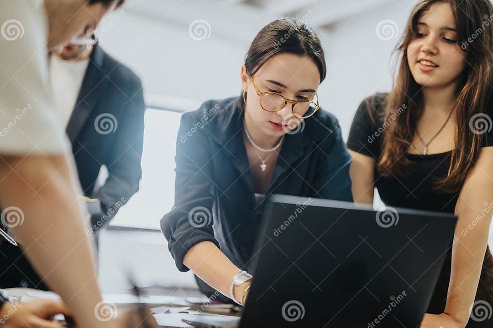 Students Collaborating on School Assignments Using a Laptop Stock Photo ...