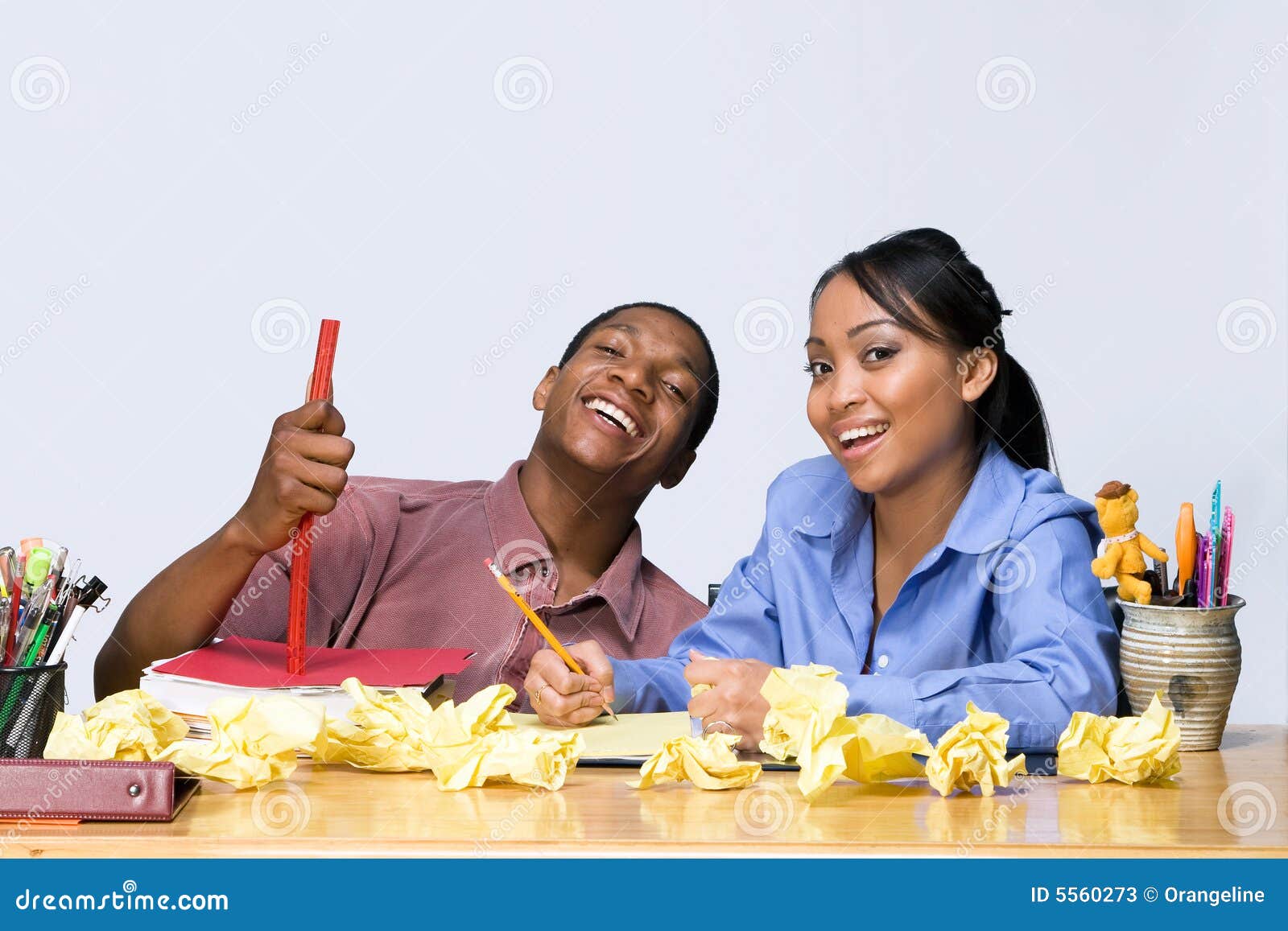 Students at Desk with Crumpled Paper - Horizontal Stock Image - Image ...