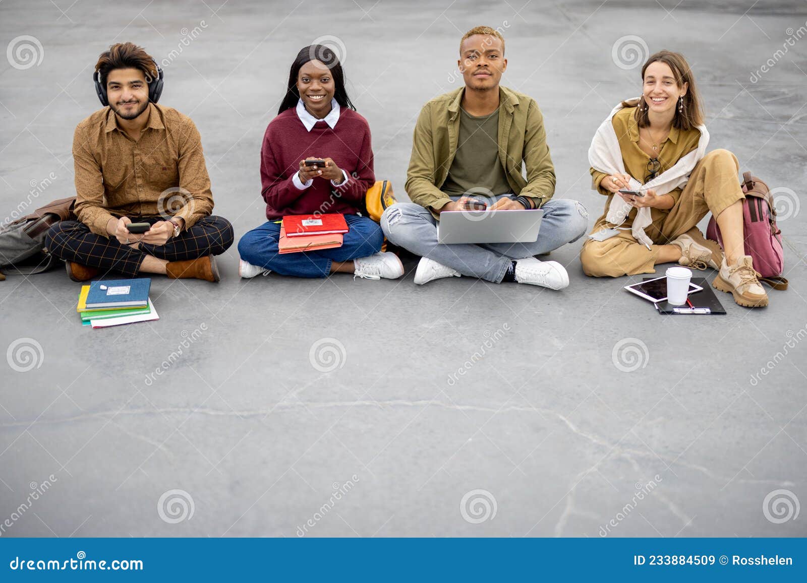 Students with Digital Devices Sitting on Asphalt Stock Image - Image of ...