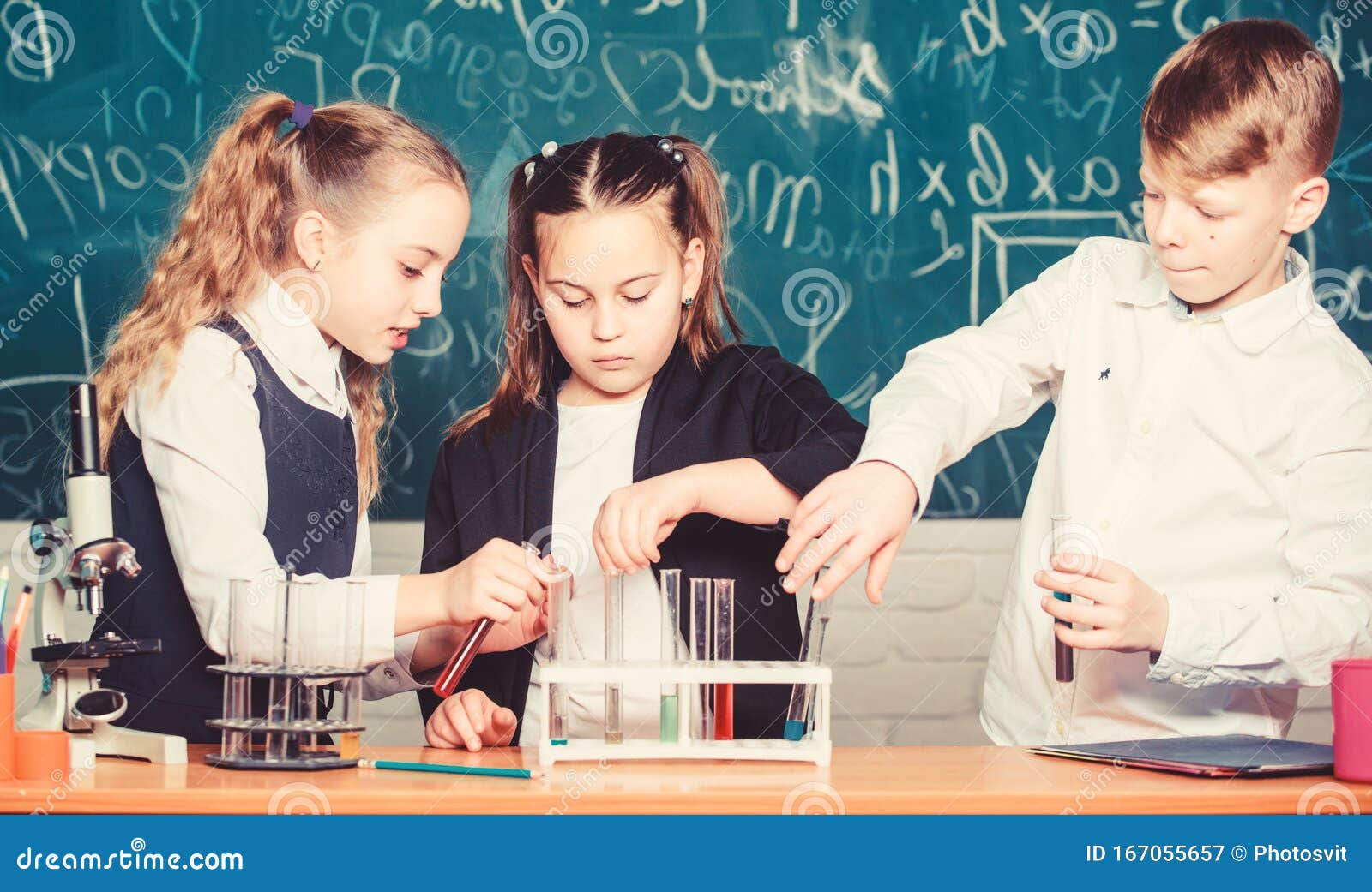 Students Doing Biology Experiments with Microscope in Lab. Little Kids ...