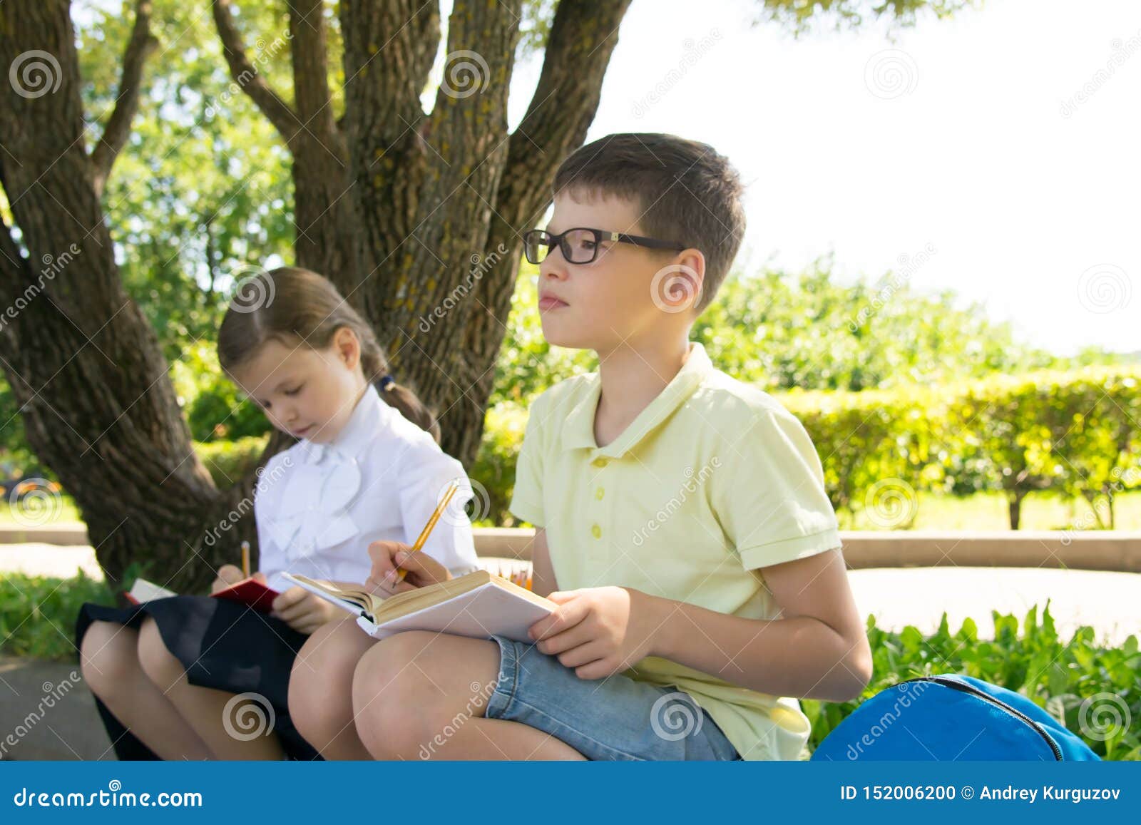 Students Doing Homework, in the Park in the Fresh Air, a Boy with ...