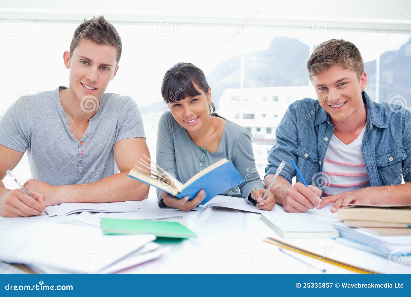 Students Doing Work Together As they All Look into the Camera Stock ...