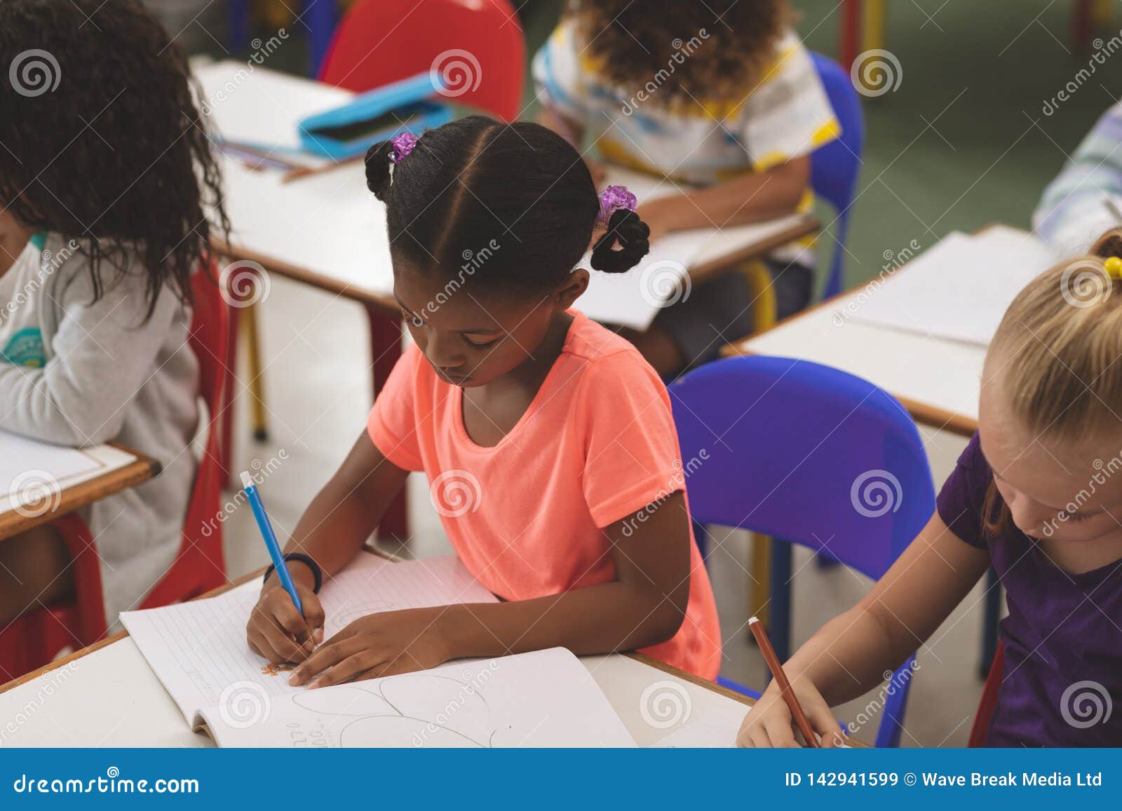 Students Drawing on Notebook in Classroom Stock Image - Image of girls ...