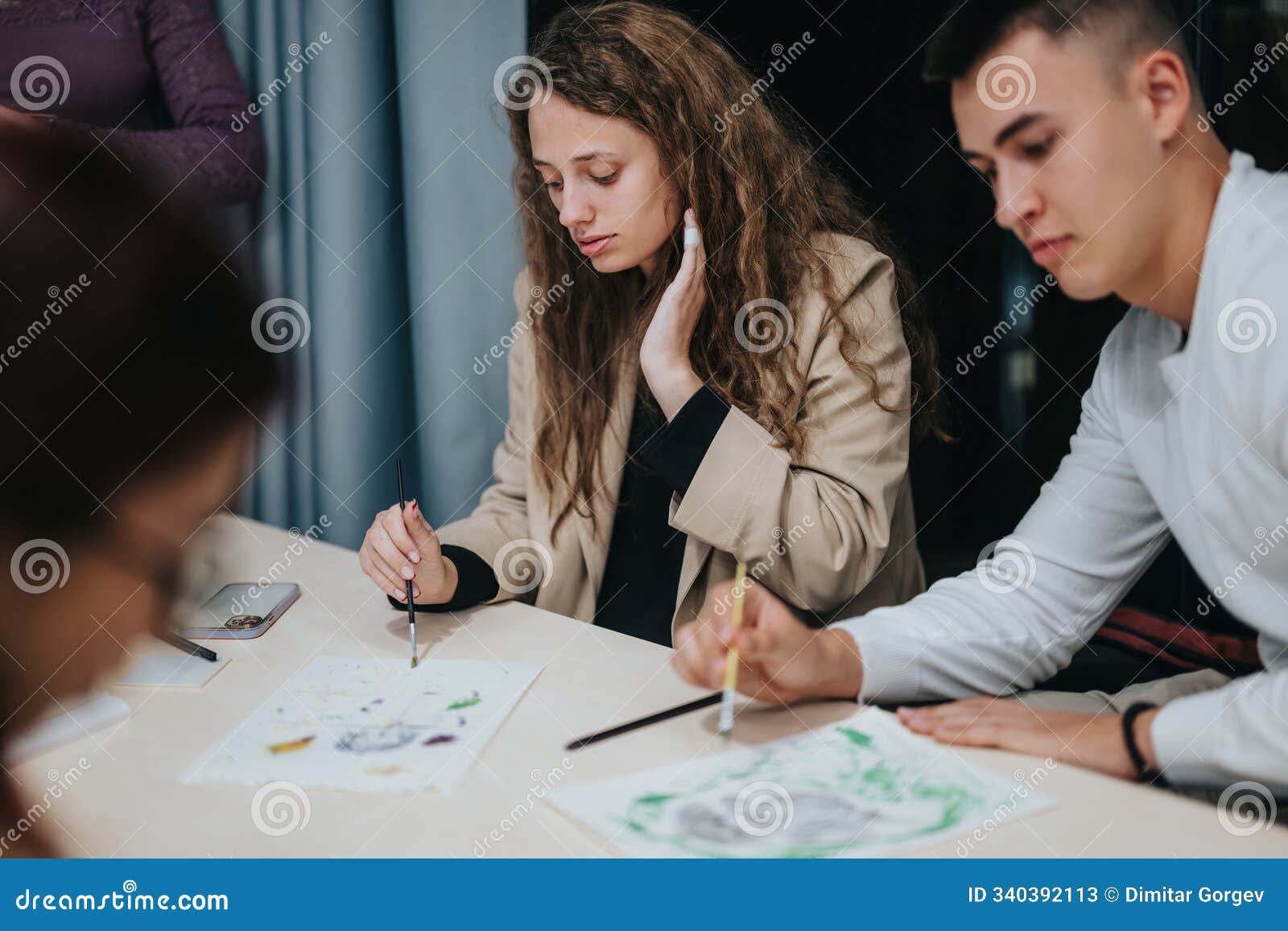 Students Engaged in a Creative Art Class Painting Together Stock Image ...