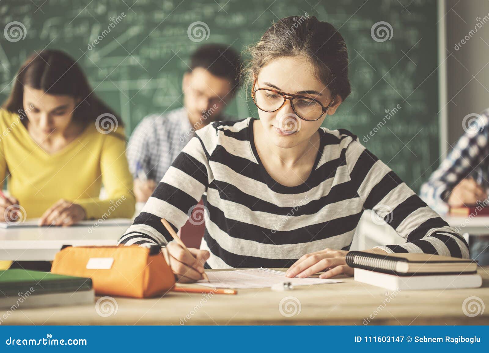 Students in Examination Solving Questions Wrting Stock Image - Image of ...