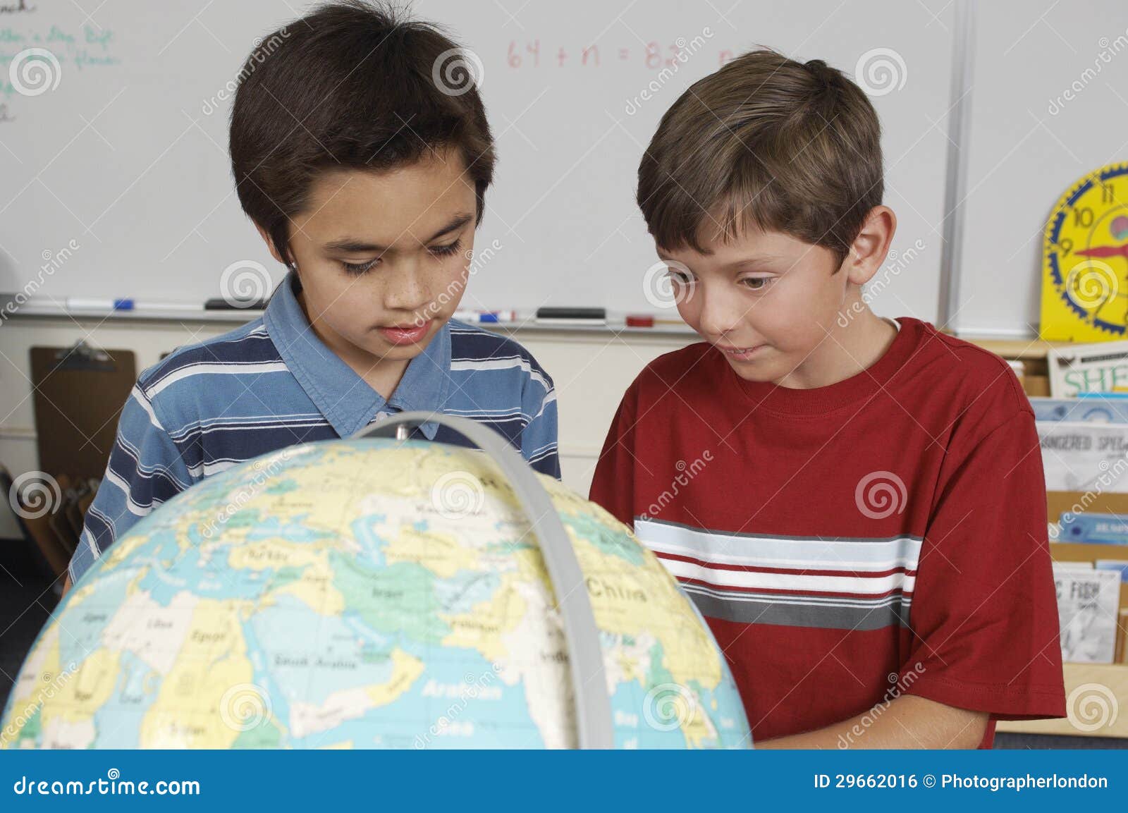 Students Examining a Globe stock photo. Image of looking - 29662016