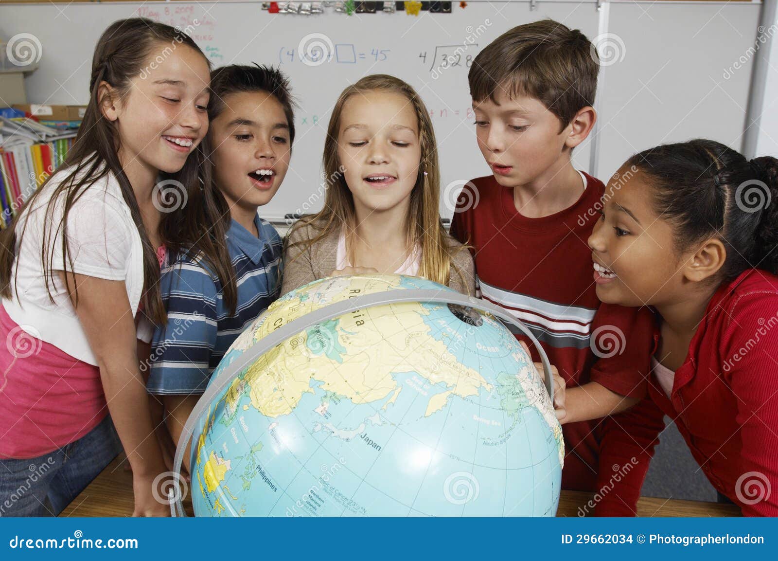 Students Examining Globe stock photo. Image of class - 29662034