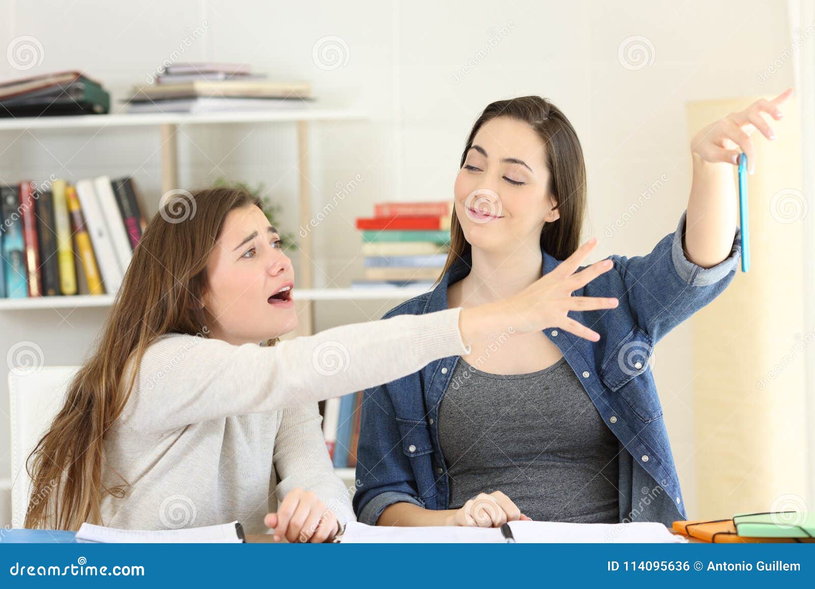 Students Fighting for a Mobile Phone Stock Photo - Image of females ...