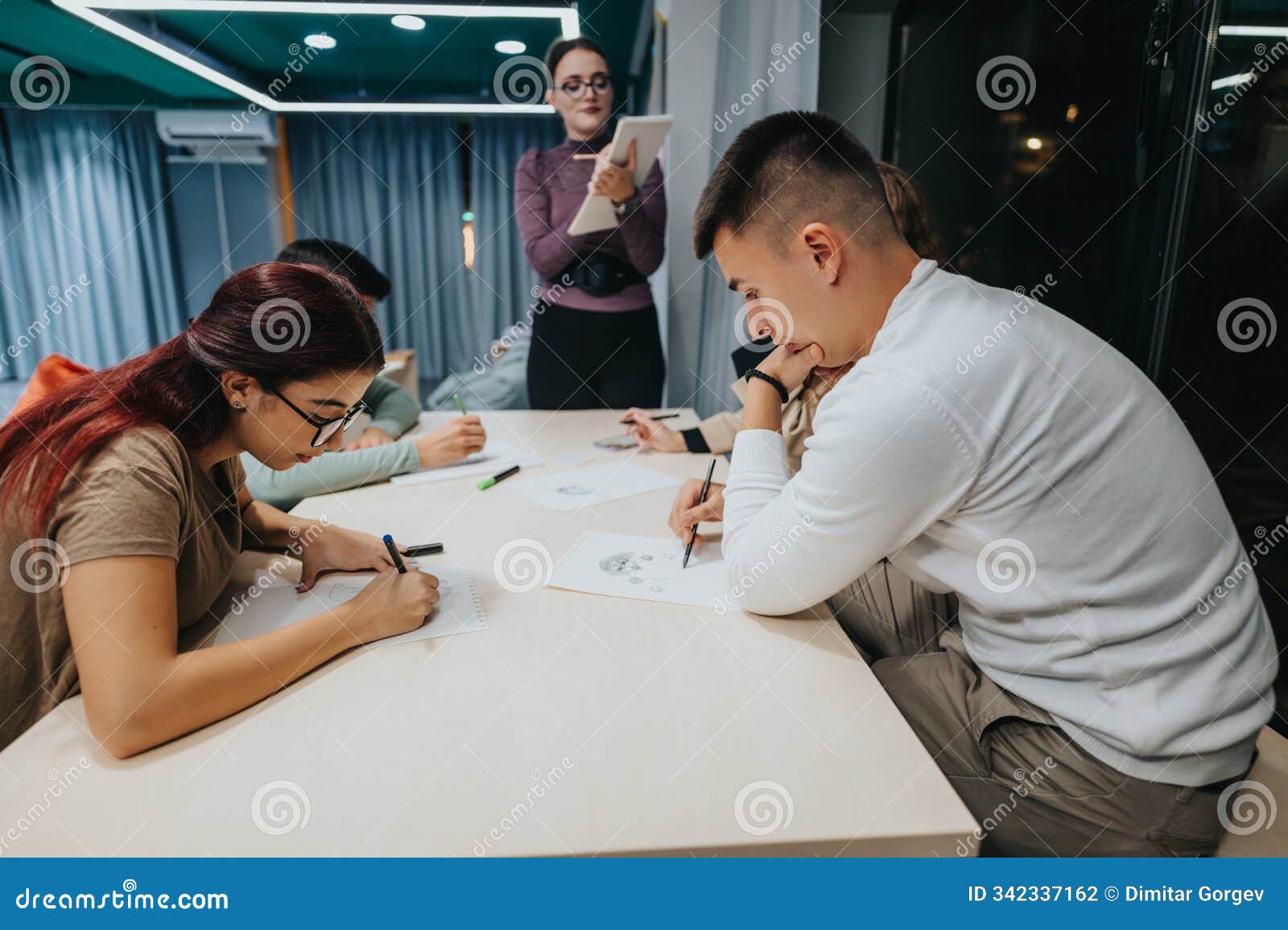 Students Focused on Drawing Exercise in Modern Classroom Stock Photo ...