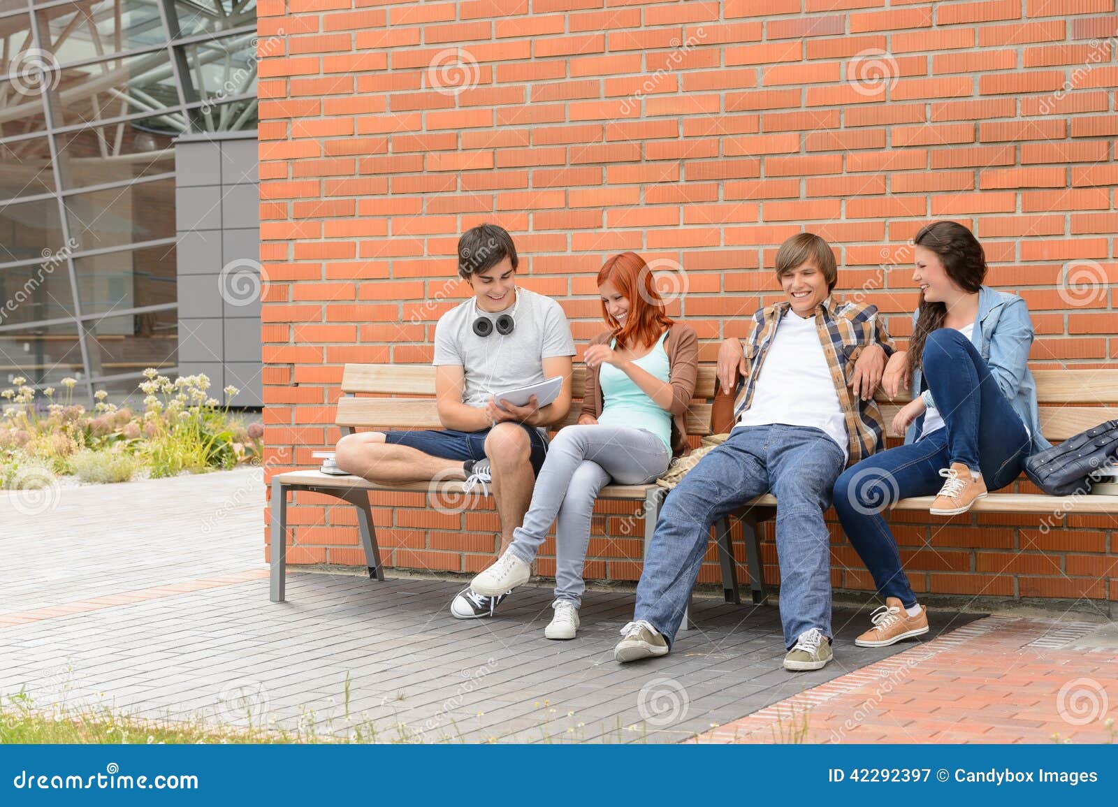 College Students Sitting On Bench