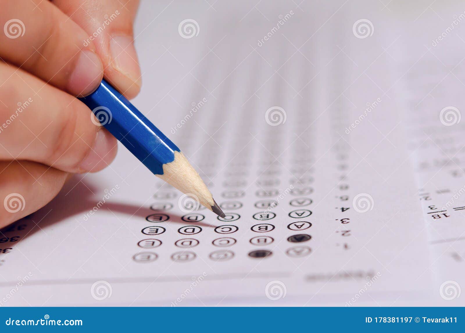 Students Hand Holding Pencil Writing Selected Choice on Answer Sheets ...