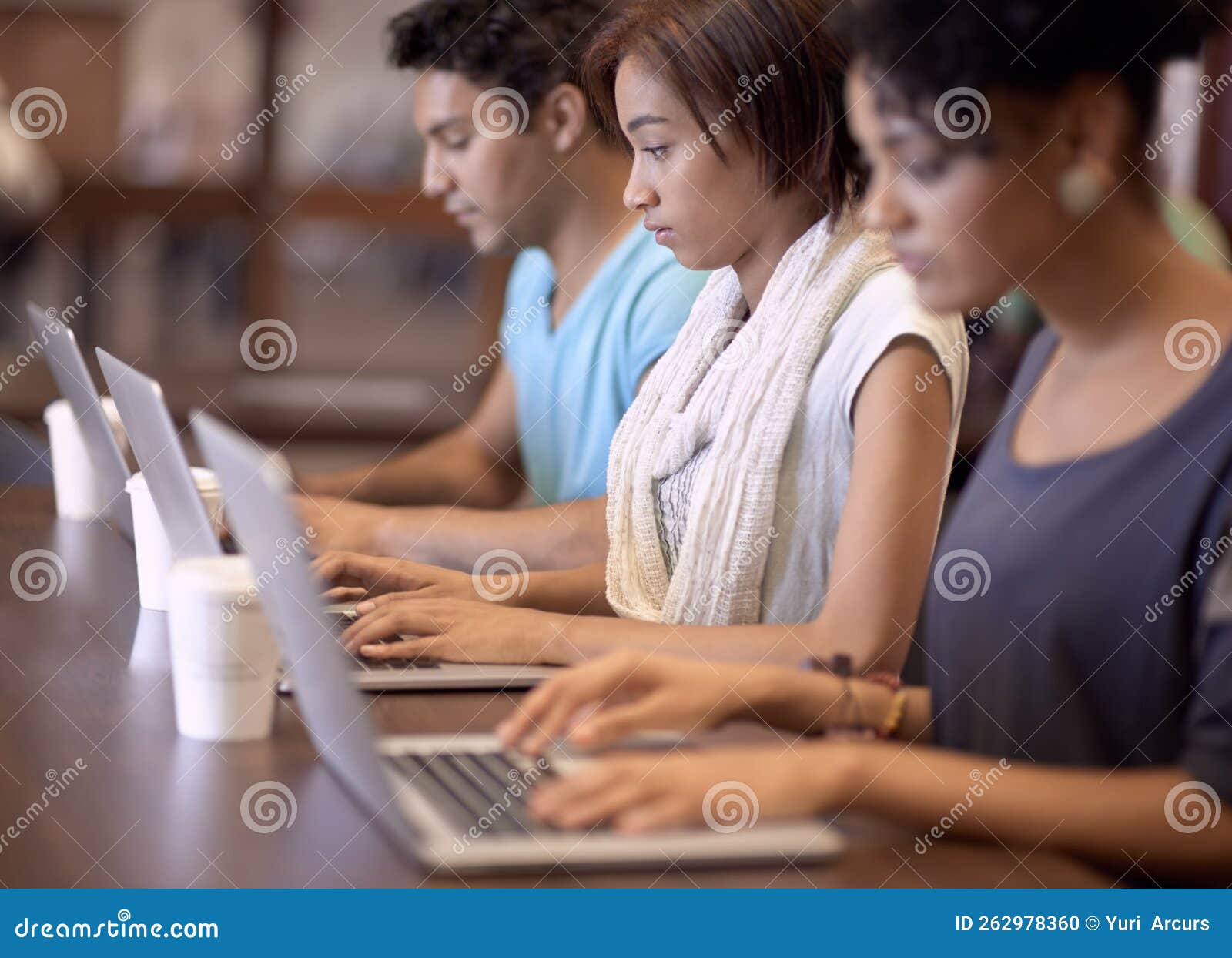 These Students are Hard at Work. a Group of Students Using a Laptop To ...