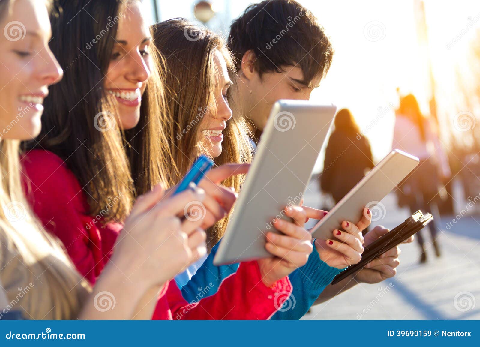 Students Having Fun with Smartphones and Tablets after Class Stock ...