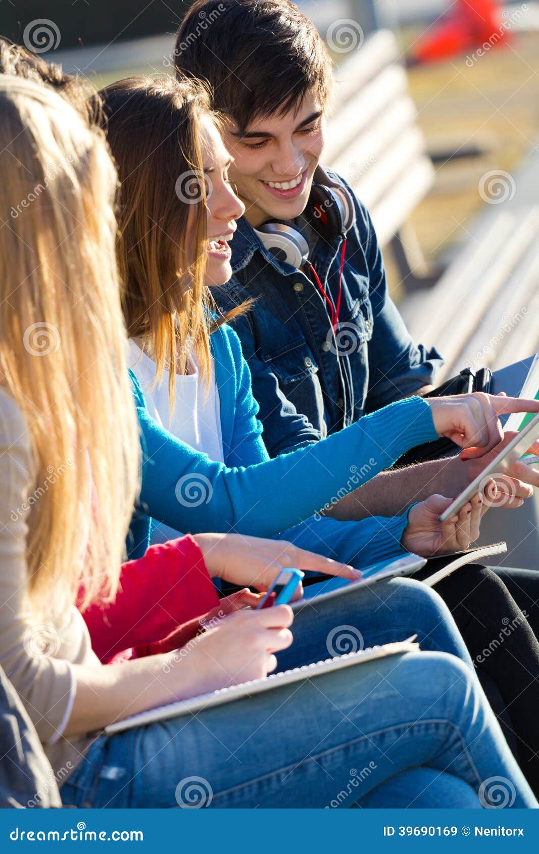 Students Having Fun with Smartphones and Tablets after Class Stock ...