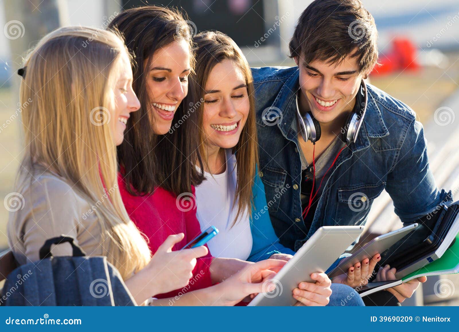 Students Having Fun with Smartphones and Tablets after Class Stock ...