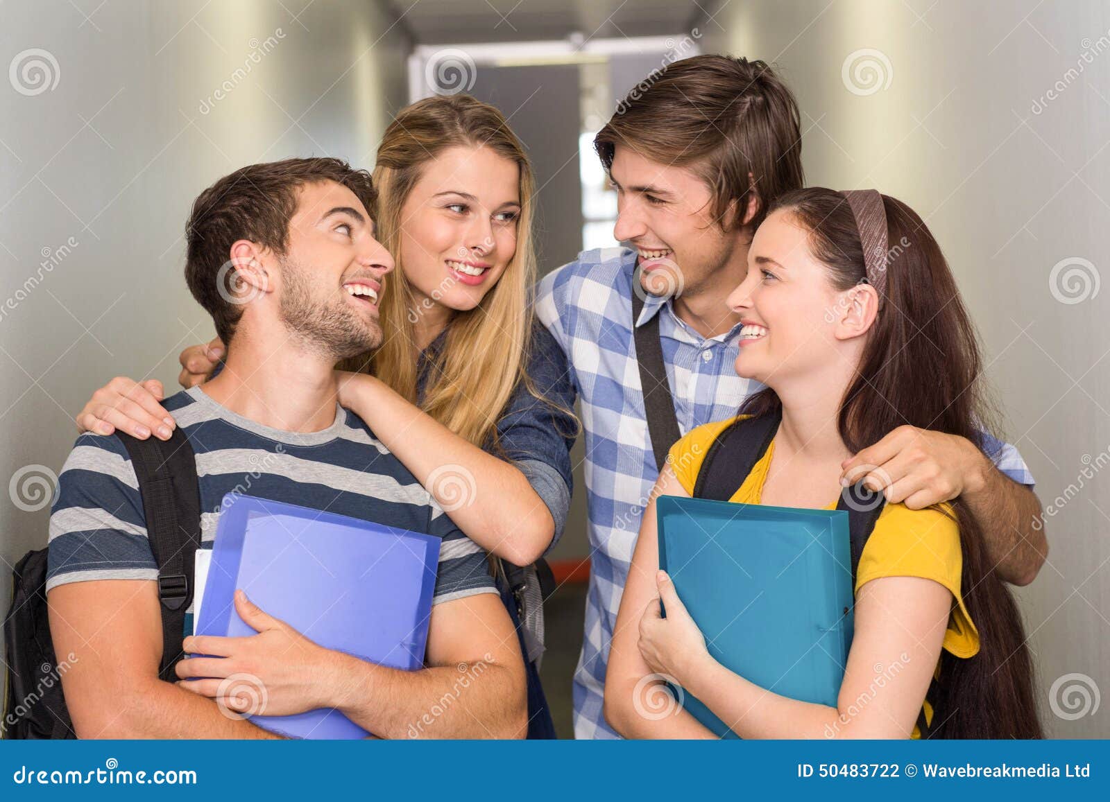 Students Holding Folders at College Corridor Stock Photo - Image of ...