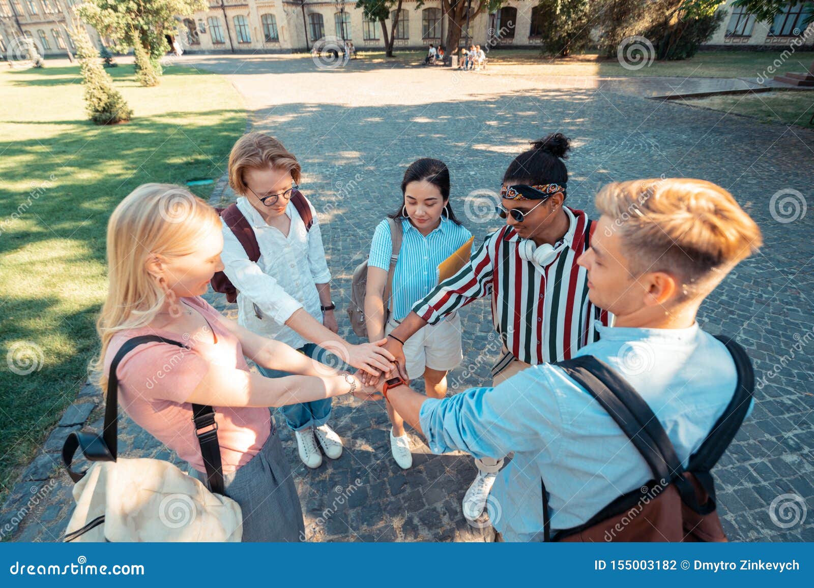 Students Holding Hands Forming a Circle in the Yard. Stock Photo ...