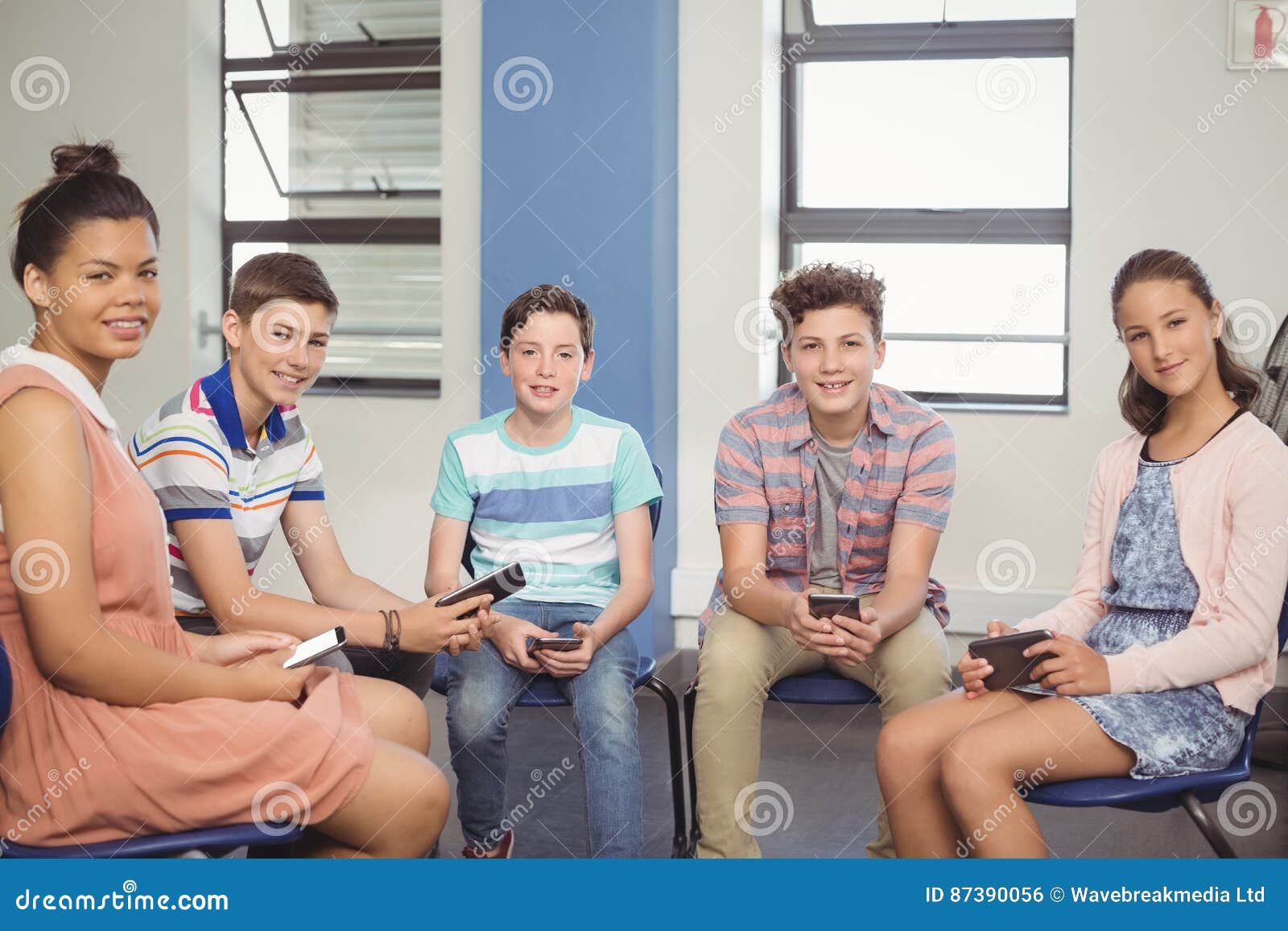 Students Holding Mobile Phone in Classroom Stock Photo - Image of ...