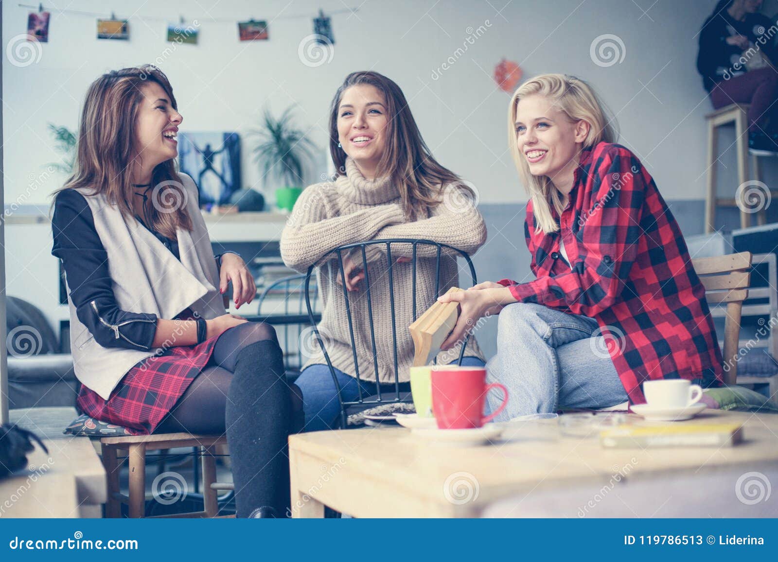 Students Learning in a Cafe. Three Friends Having Conversation Stock ...