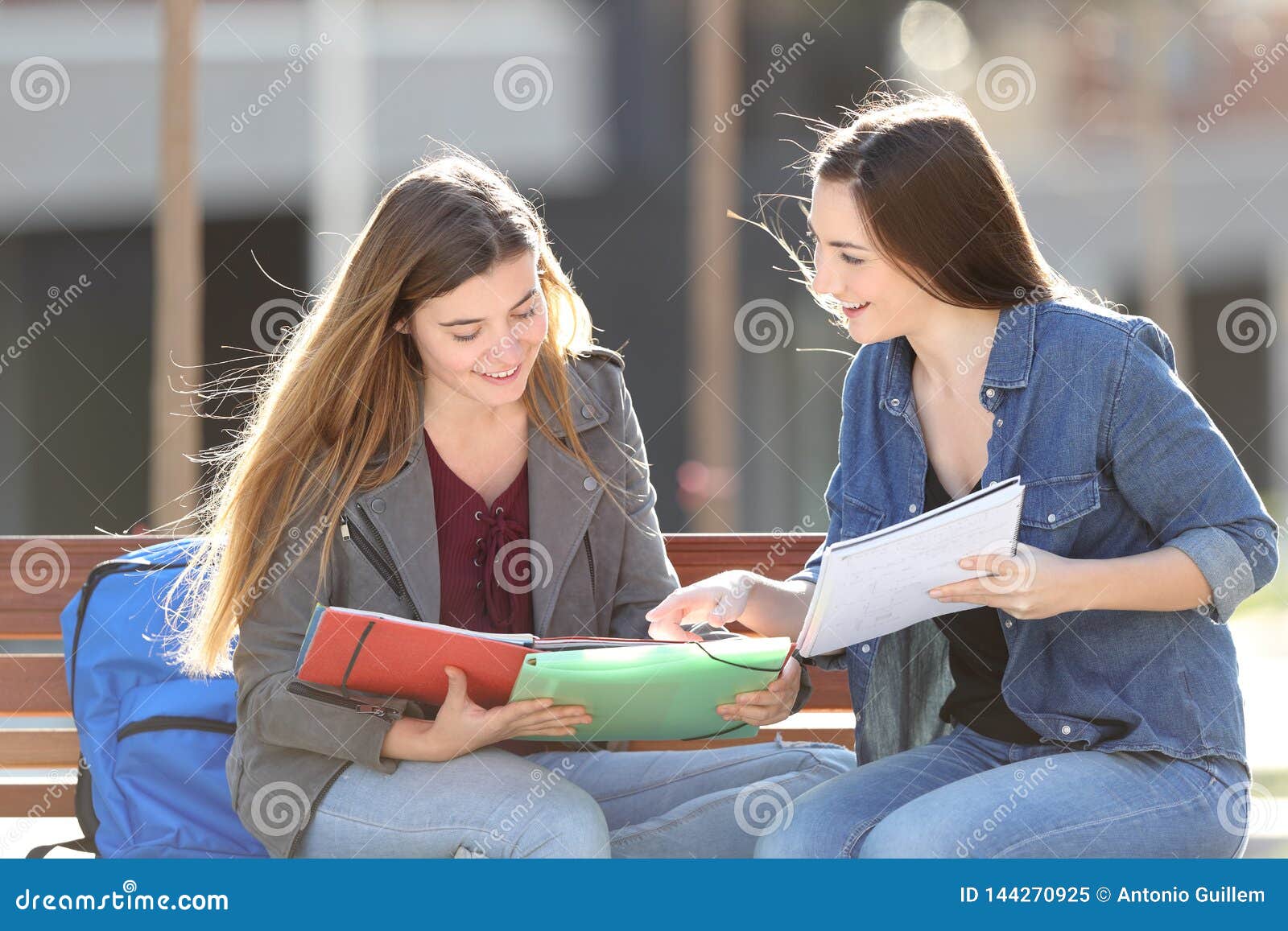 Students Learning Comparing Notes on a Bench Stock Image - Image of ...