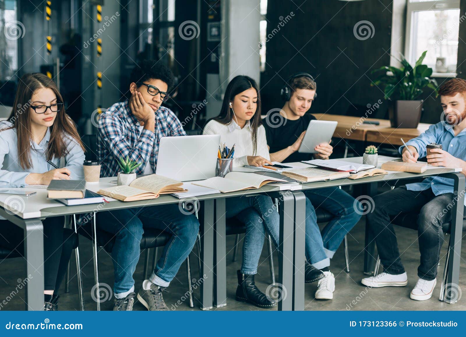 Students in Library. Tired Teens Doing Homework Stock Photo - Image of ...