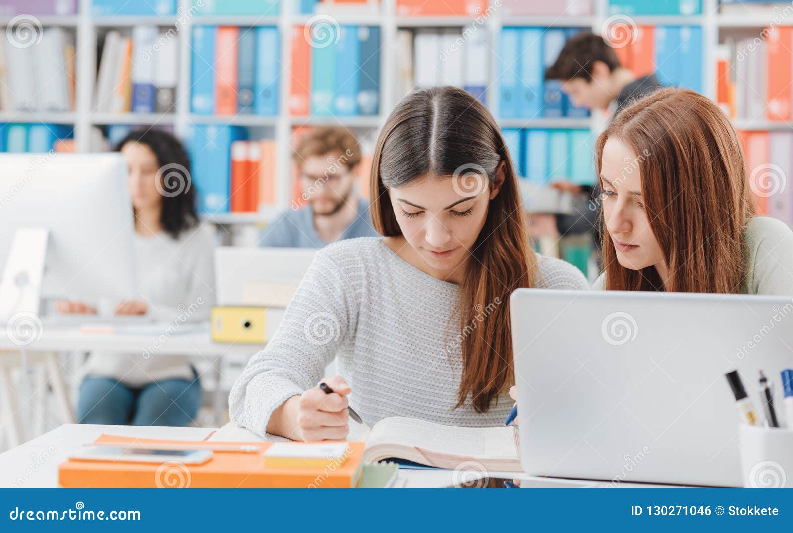 Students at the library stock photo. Image of helping - 130271046