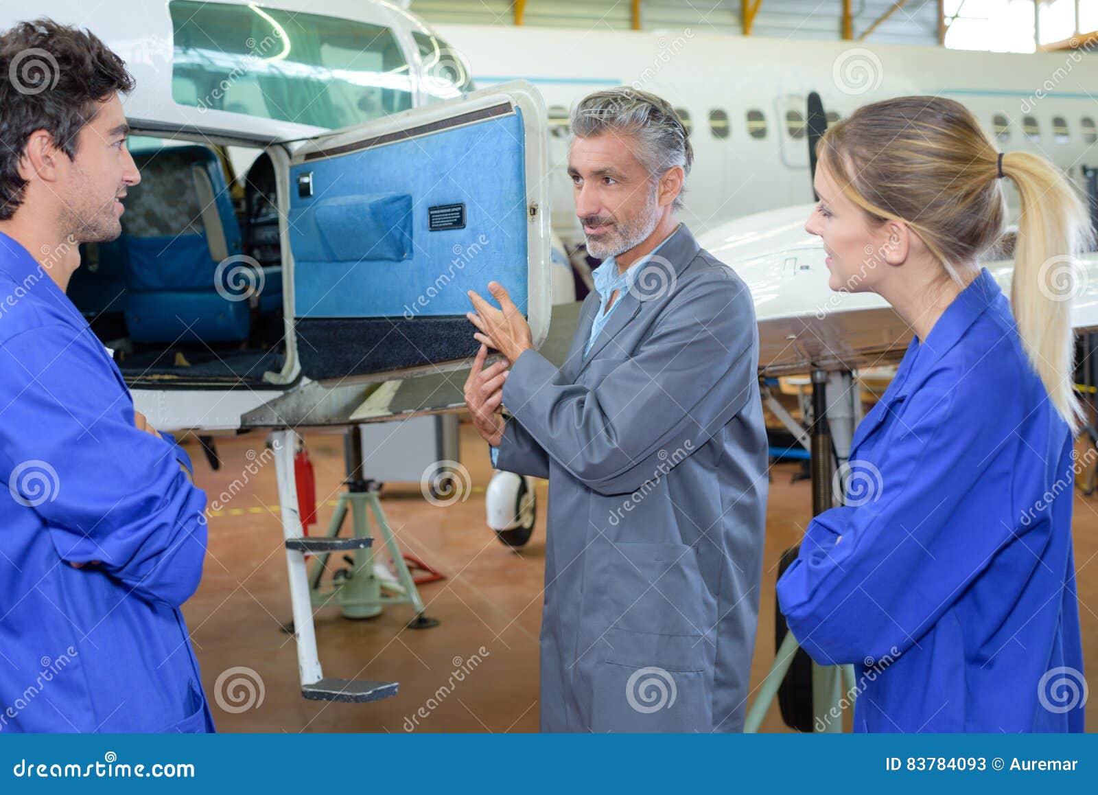 Students Looking in Compartment Aircraft Stock Image - Image of smile ...