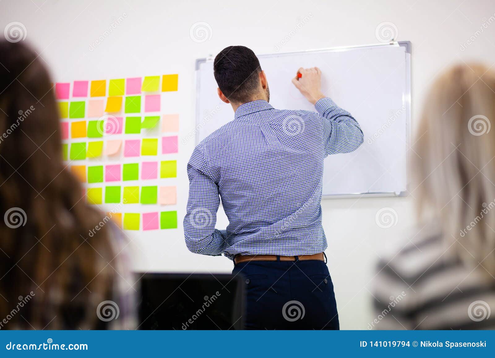Students Looking at Professor Writing on Table Stock Photo - Image of ...