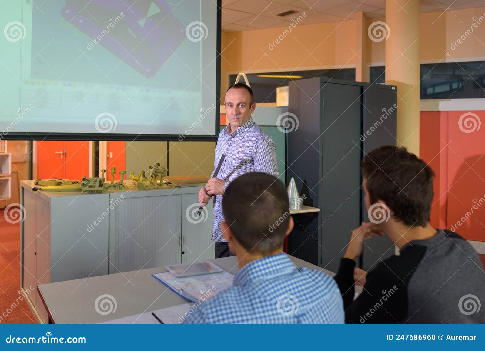 Students Looking at Teacher and Projector Screen Stock Photo - Image of ...