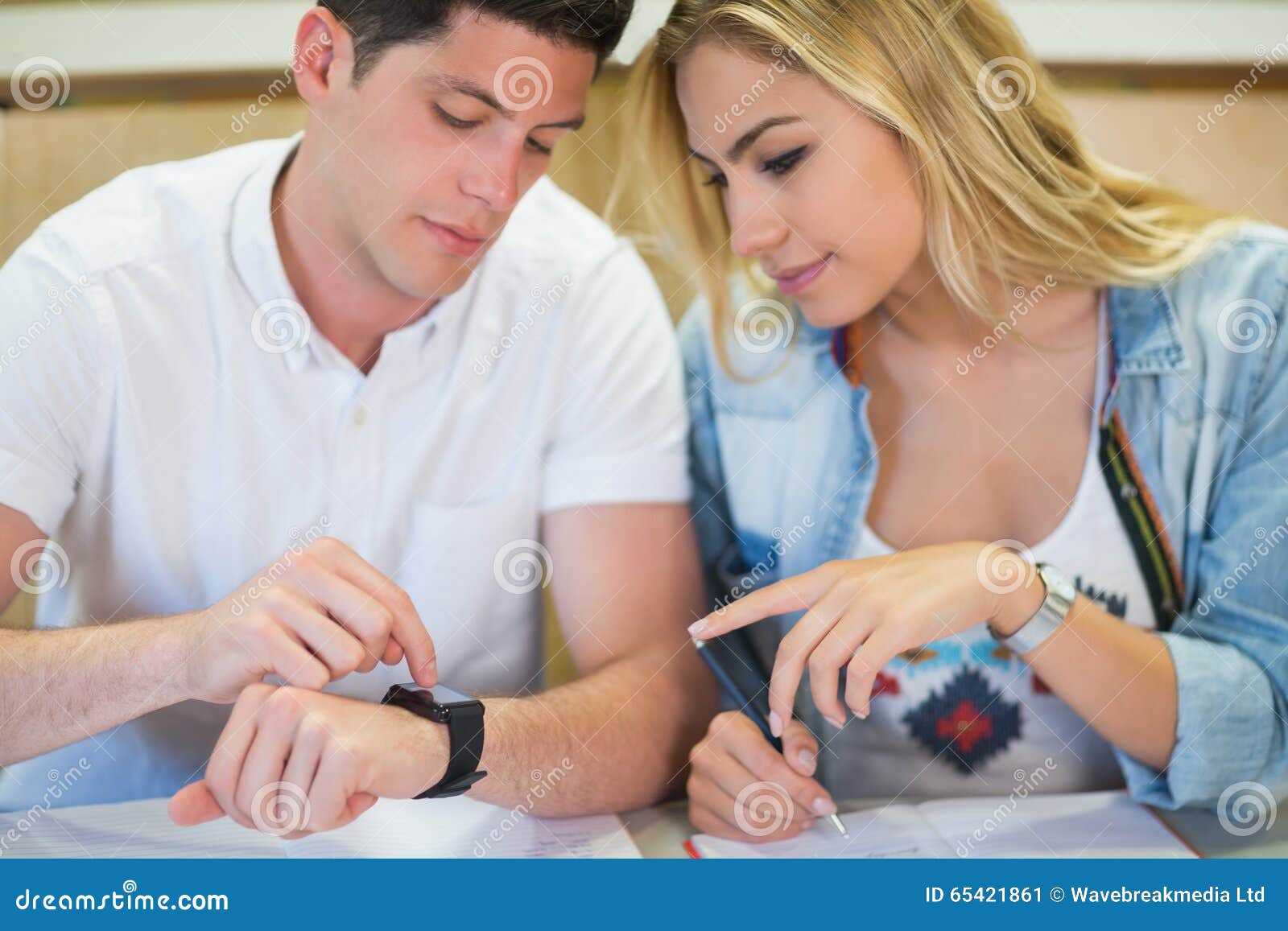 Students Looking at Watch while Studying Stock Image - Image of female ...